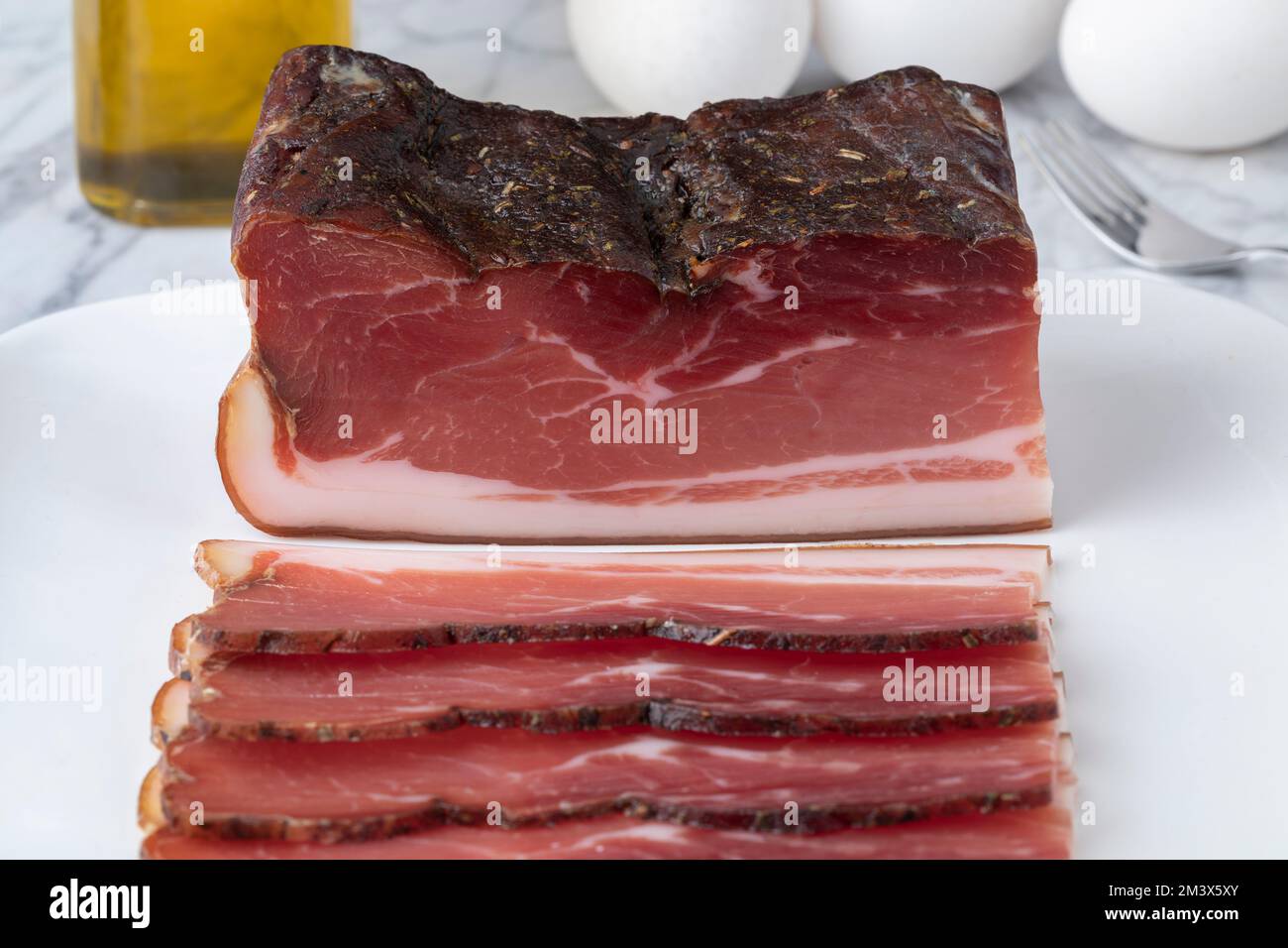 Traditional german smoked bacon, Sudtiroler Speck, and slices close up ...
