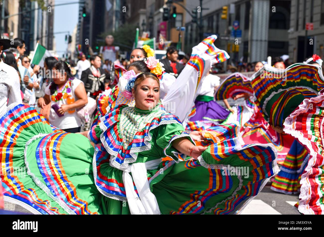 A beautiful dancer in a colorful costume performing during the Mexican ...