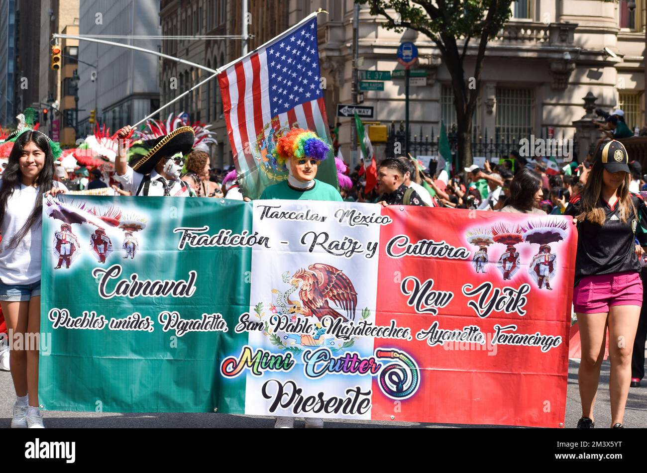 The flag of Mexico with several notes and people gathered during the ...