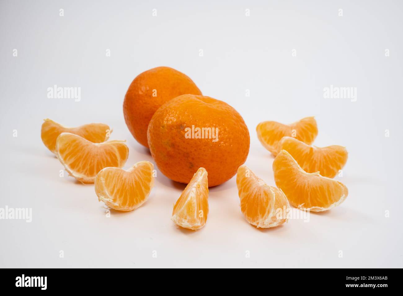 couple of satsumas tangerines with orange segments isolated on a clean ...