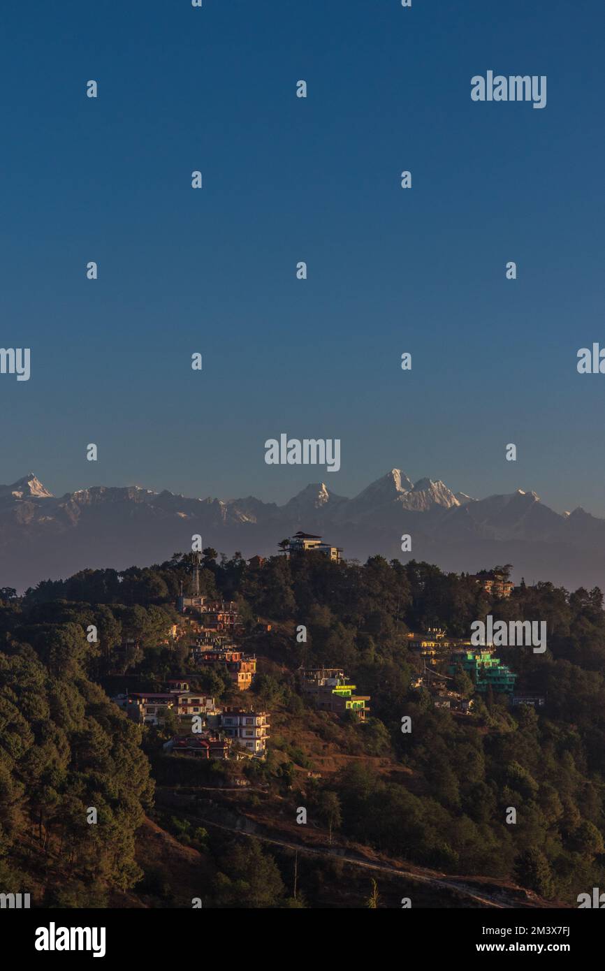 A vertical shot of the Himalayas mountains in the background of ...