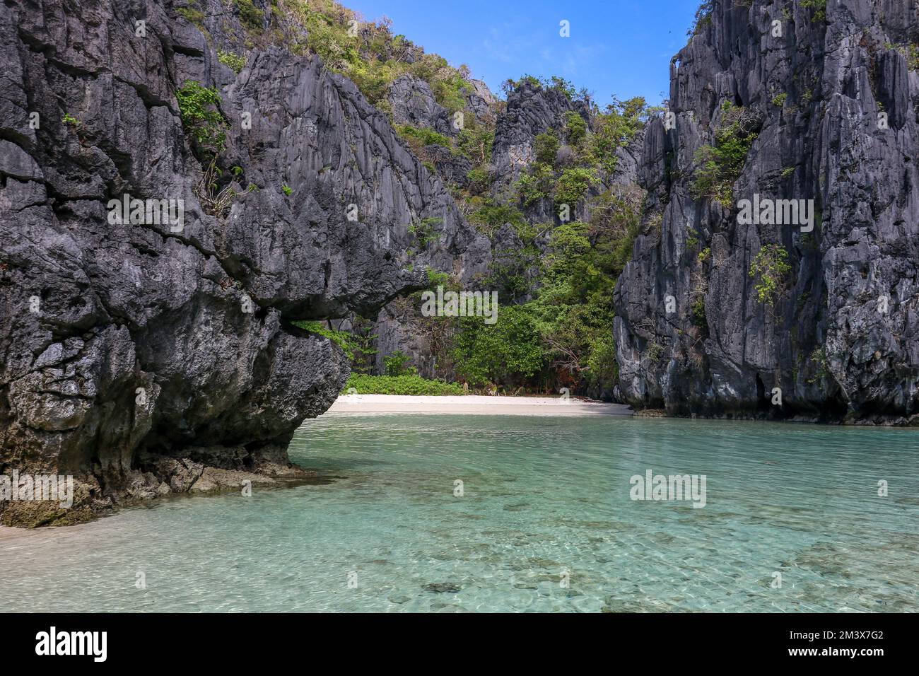 The Hidden Beach with rocky cliffs in El Nido, Philippines Stock Photo ...