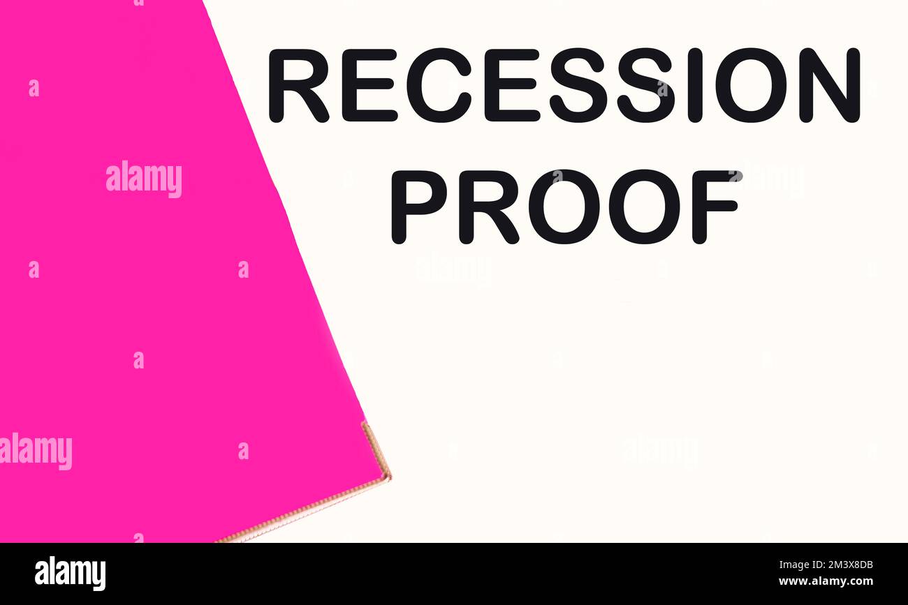 Recession proof concept writing on white background with pink folder ...