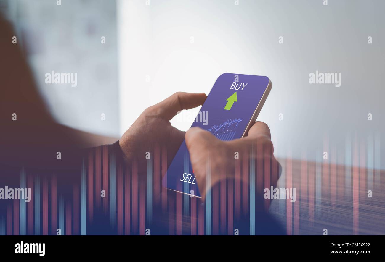 Male trader investor analyst holding smartphone in hand analyzing stock ...