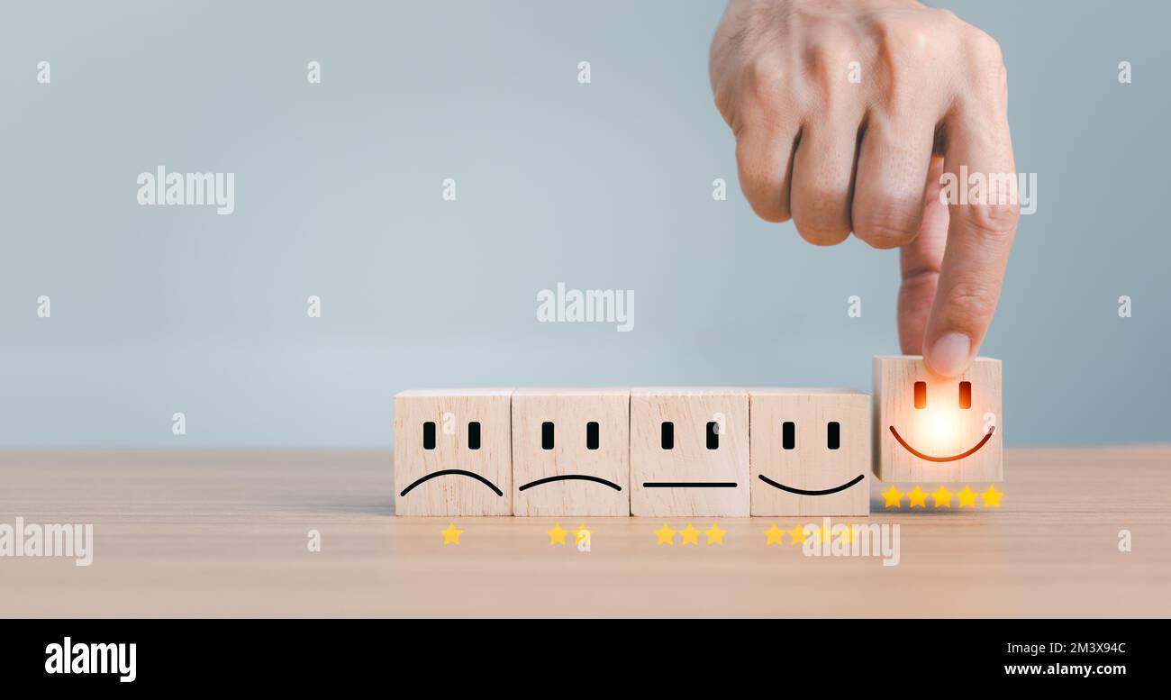 Close up customer hand choose smile face and blurred sad face icon on ...