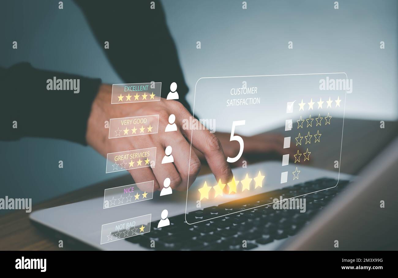 Man hand using computer Notebook with popup five star icon for feedback ...