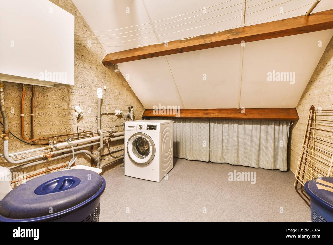 a laundry room with a washer, dryer and washing machine on the floor in ...