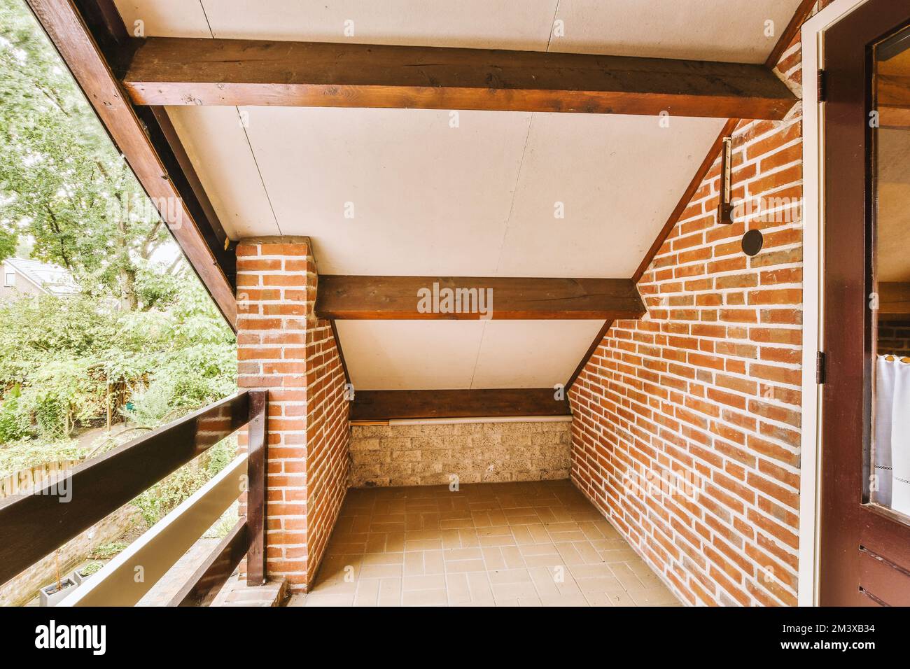 an outdoor kitchen area with brick walls and wood trim on the ceiling ...