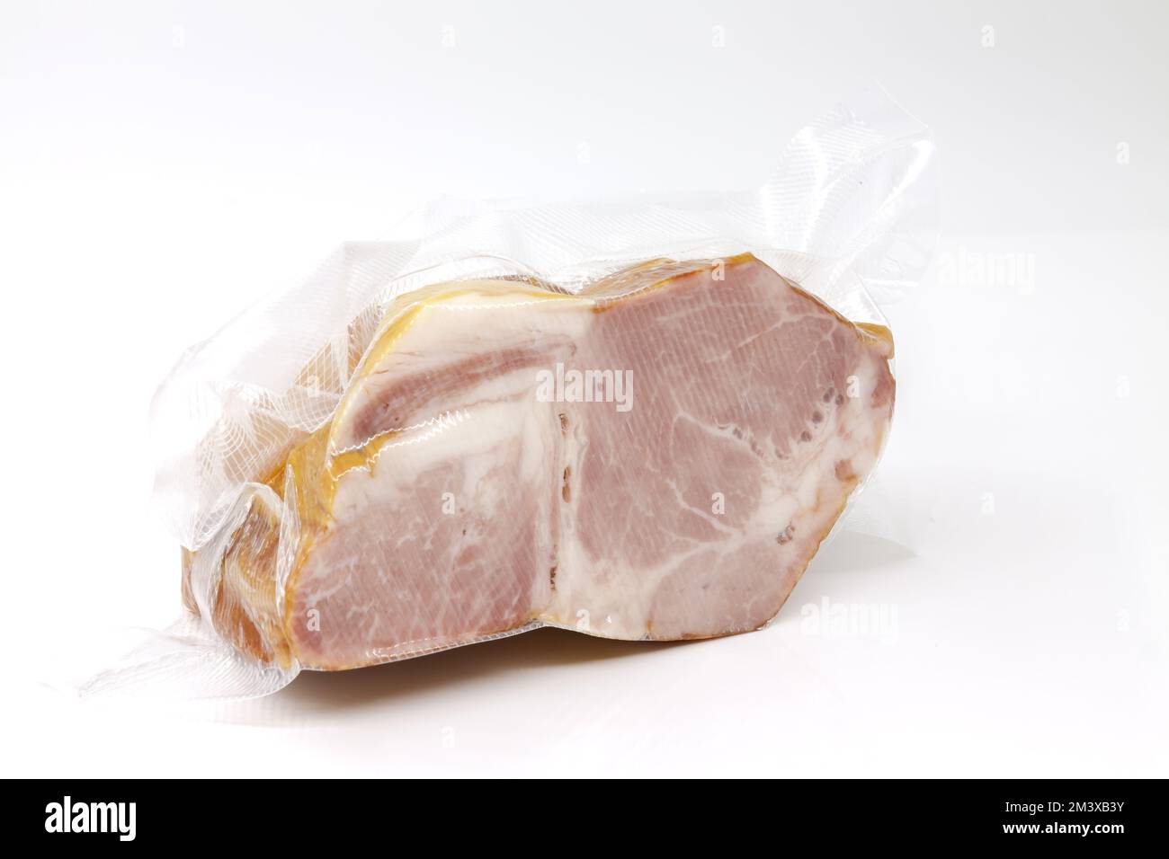 Smoked pork in vacuum packaging. Selective focus with shallow depth of ...