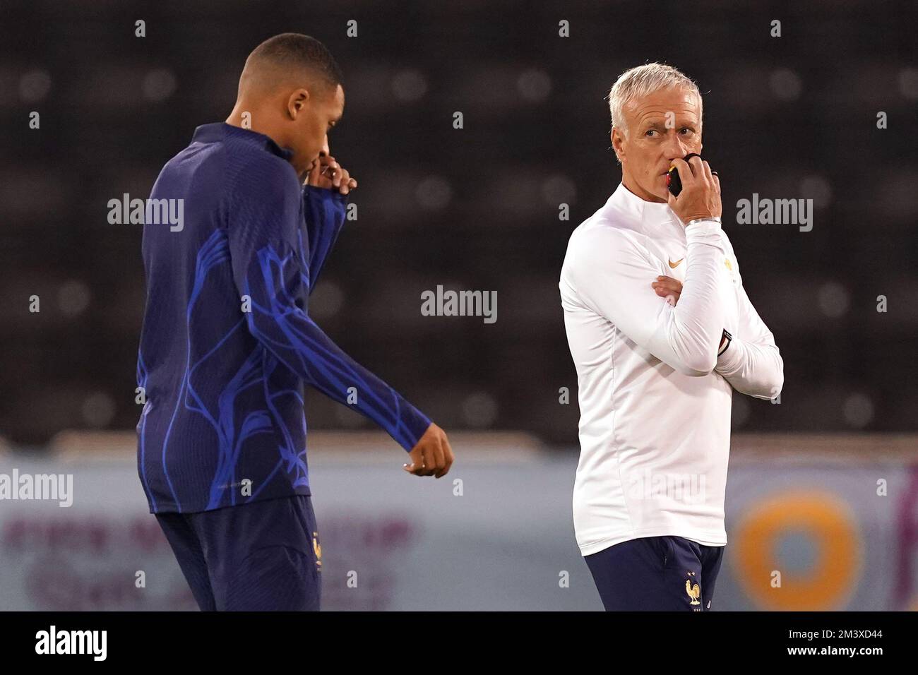 France manager Didier Deschamps (right) speaks with Kylian Mbappe ...