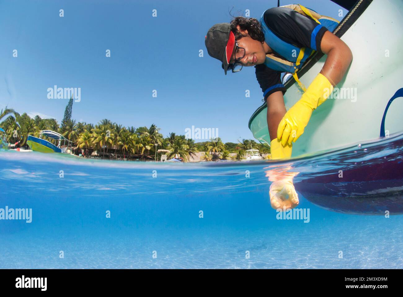 Marine Biologist taking samples of water from a boat for water quality ...