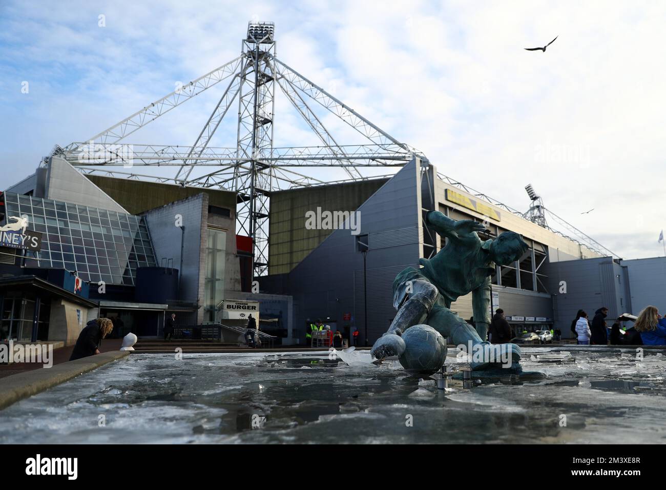 Frozen ice surrounds the Sir Tom Finney statue outside the stadium ...