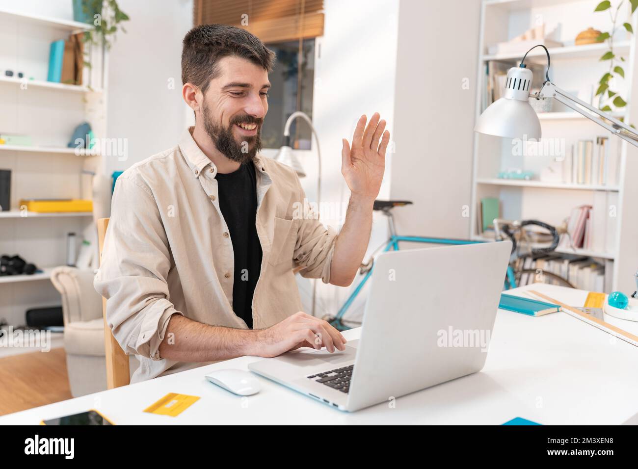 Smiling millennial man working hi-res stock photography and images - Alamy