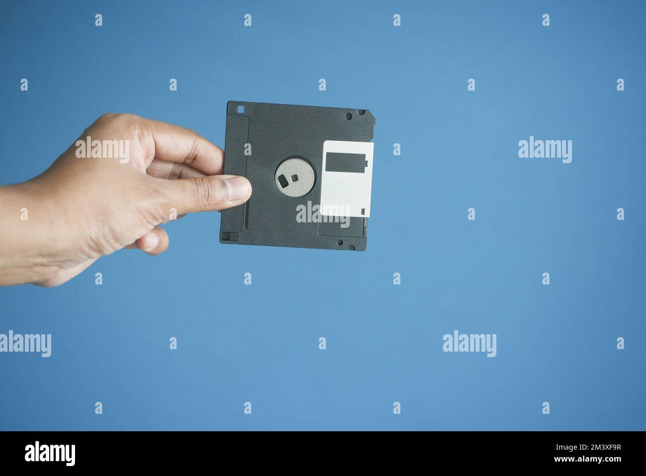 holding a an old vintage floppy disk Stock Photo - Alamy
