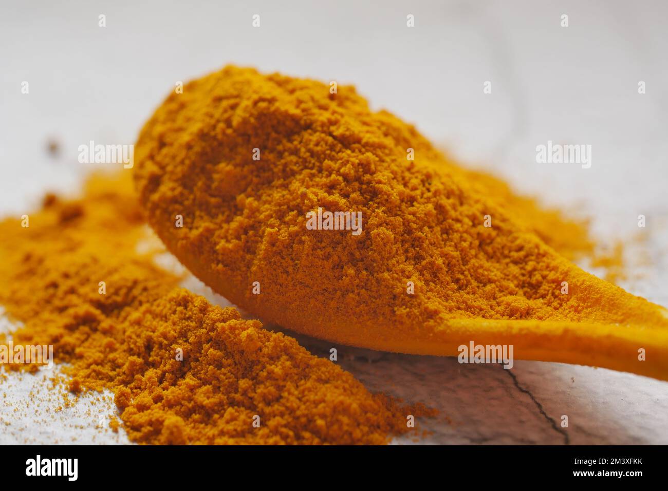 turmeric root powder on spoon Stock Photo - Alamy