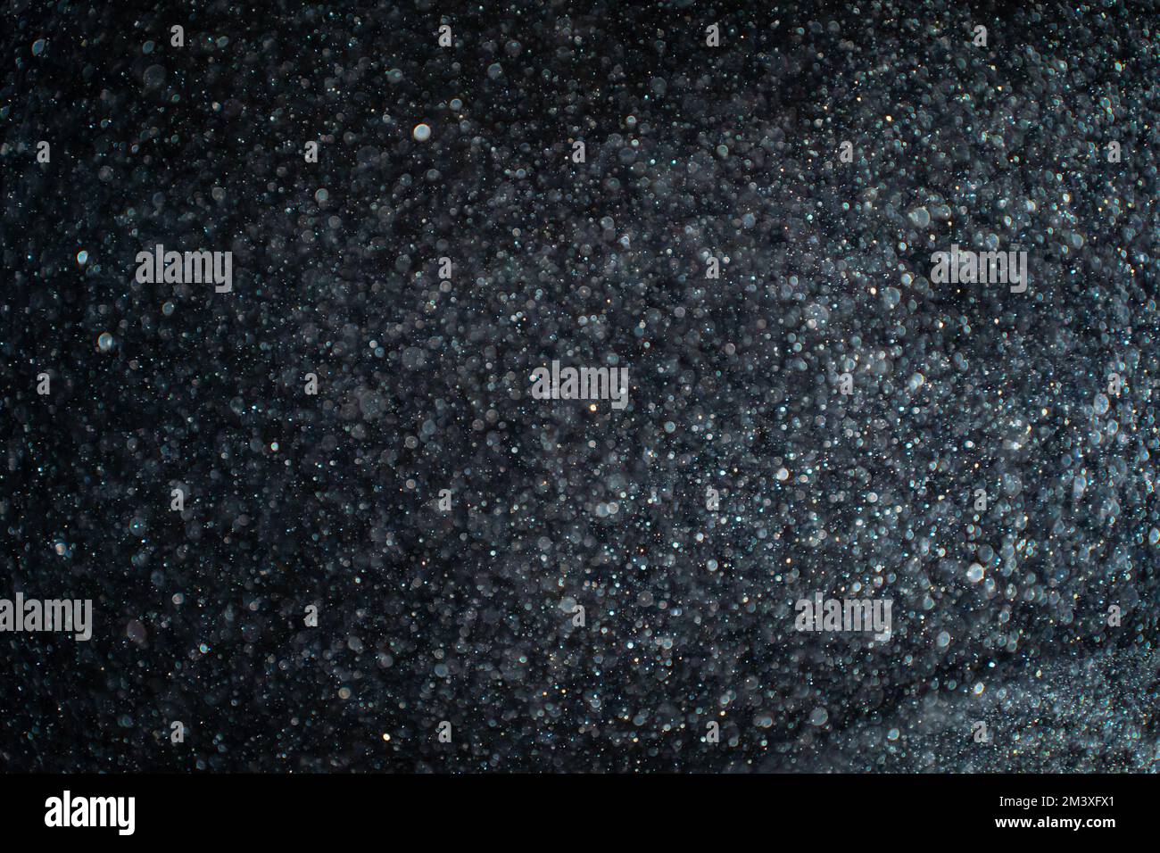 Abstract real dust particles on black background glittering sparkling ...