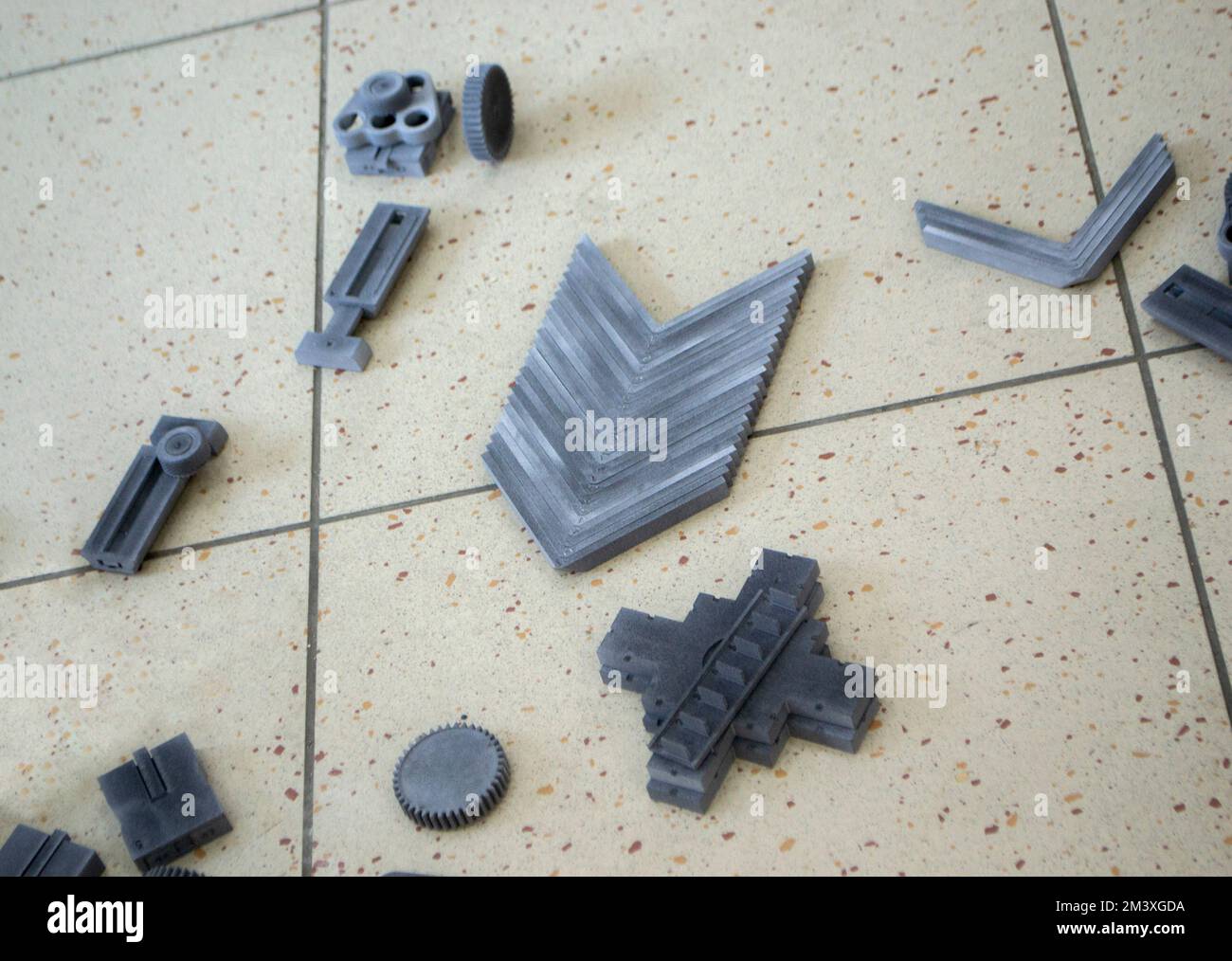 Gray models printed on 3D printer from polyamide powder on surface ...