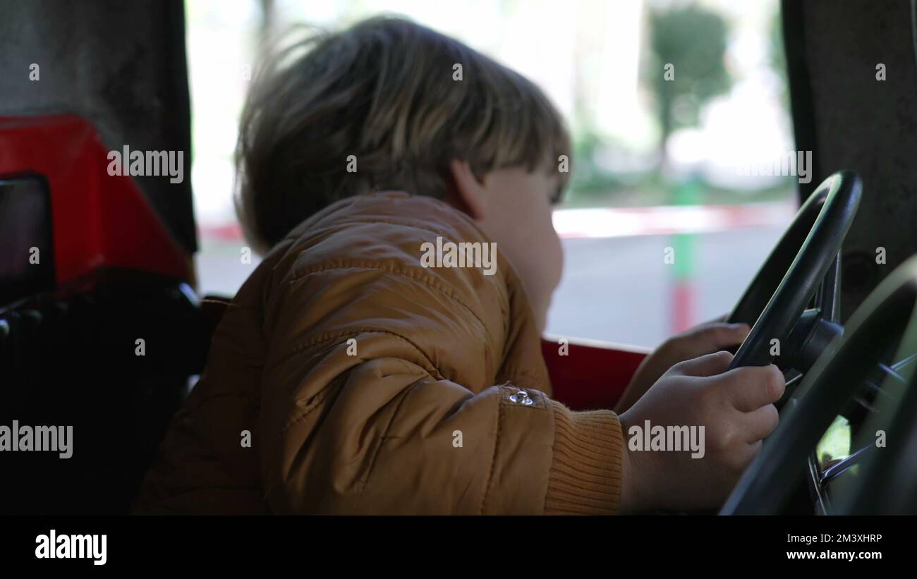 Child hands holding steering wheel pretending to be driving at ...