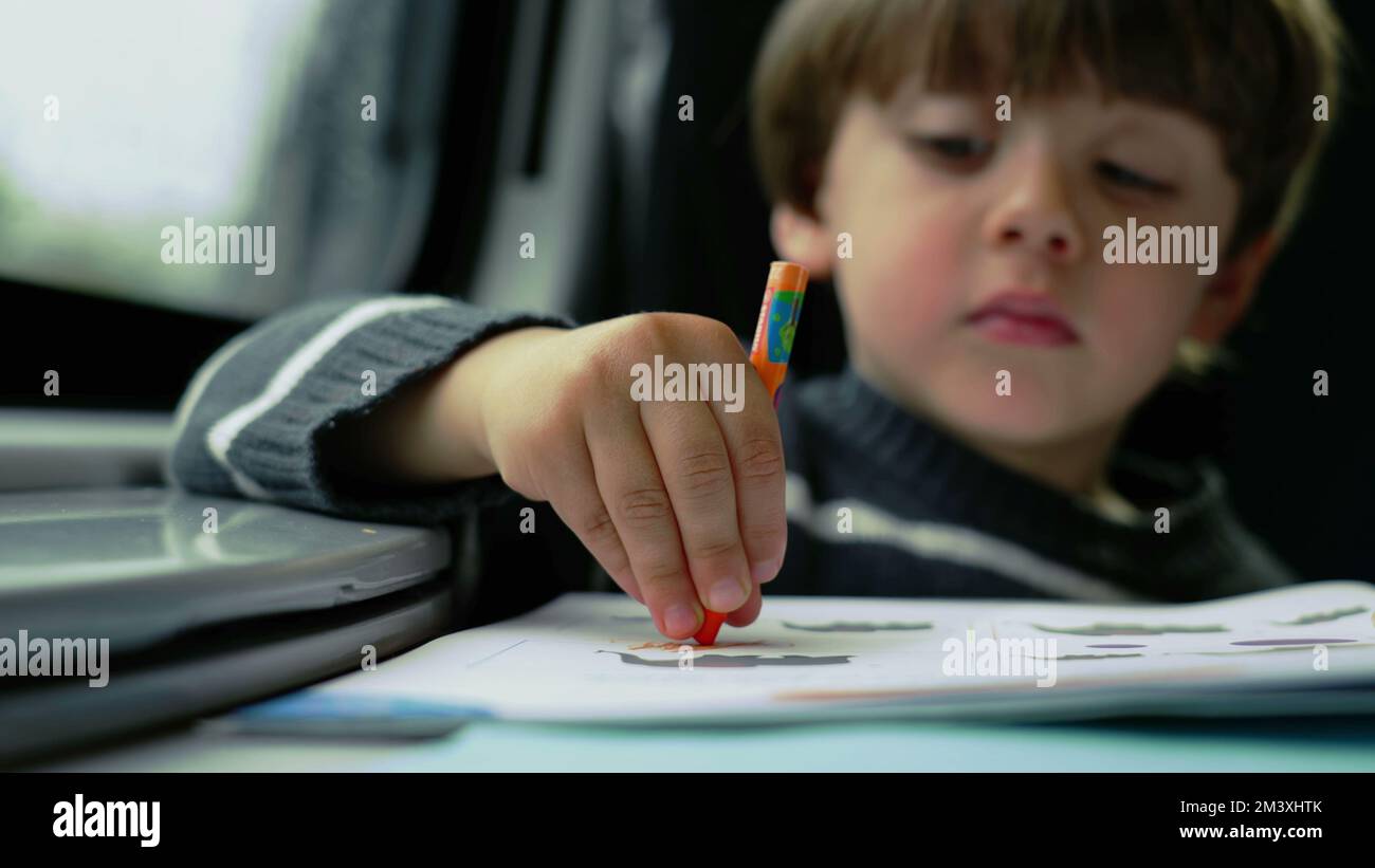 One happy child doing homework activity inside a moving train ...