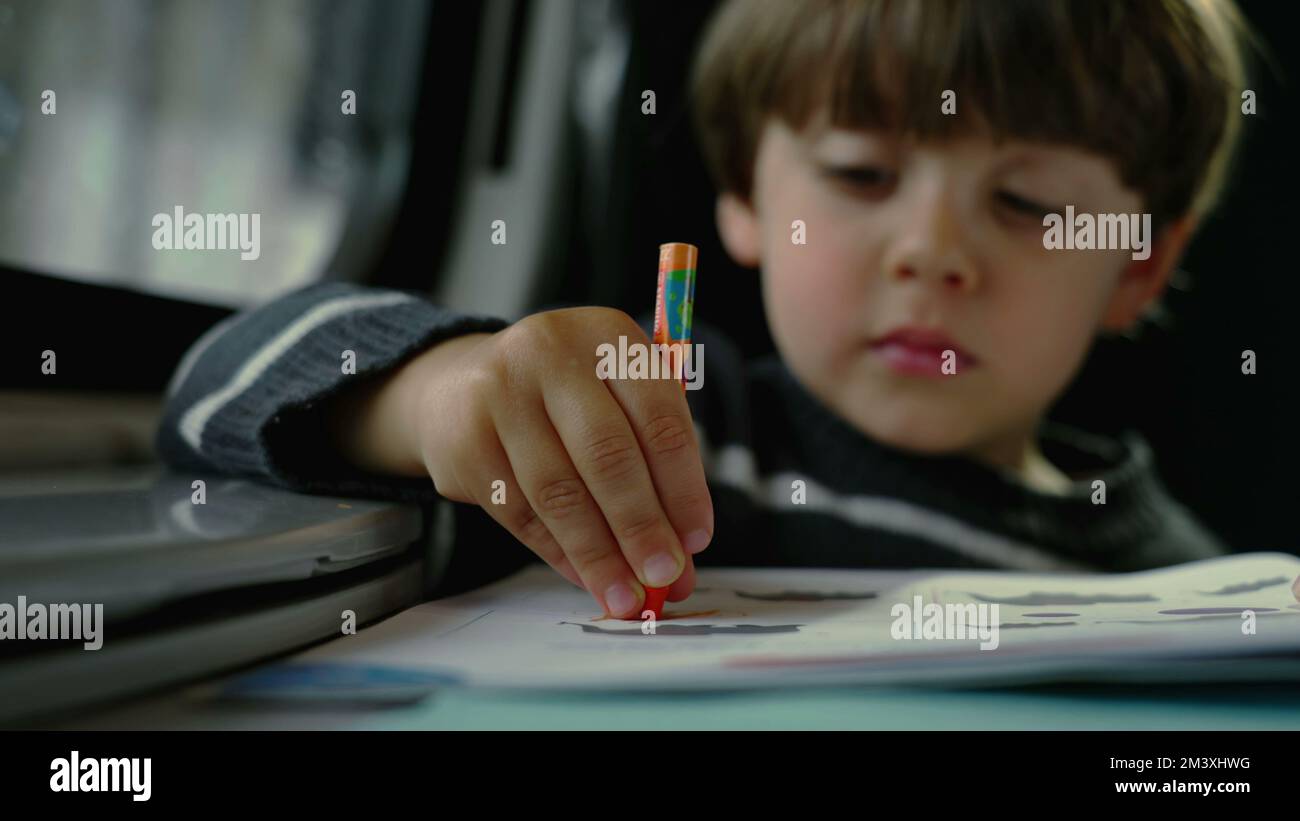 One happy child doing homework activity inside a moving train ...