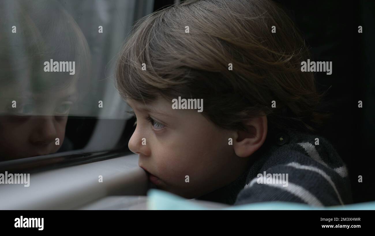 One sleepy little boy almost falling asleep while traveling on train in ...