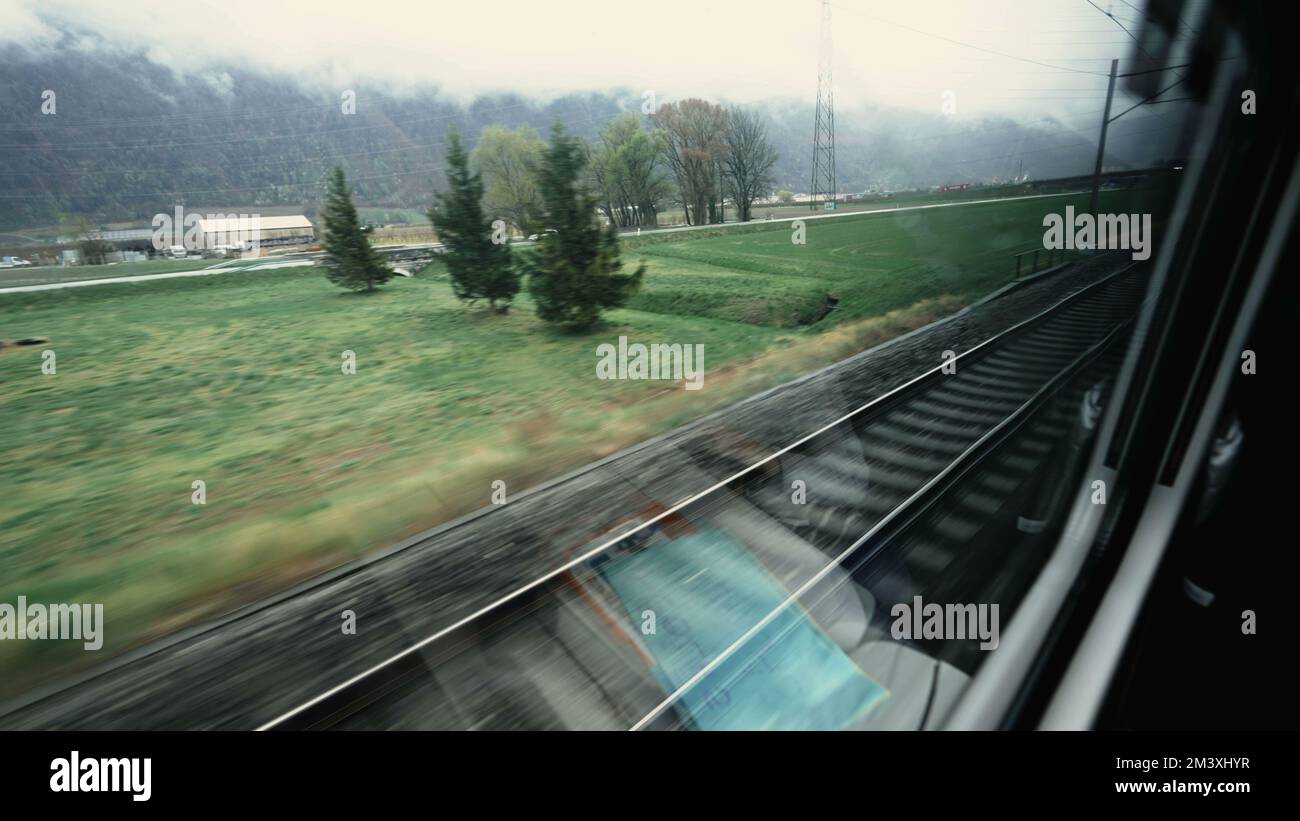Window perspective of railroad passing by high speed train. Traveling ...