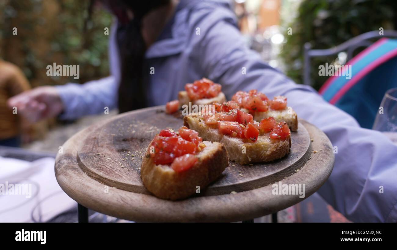 Bruschetta food on wooden plate at restaurant. Traditional Italian meal ...