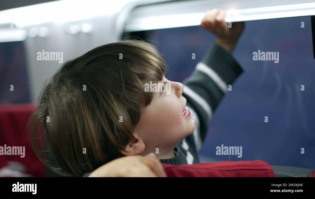 Child standing on train seat traveling inside high speed train. closeup ...