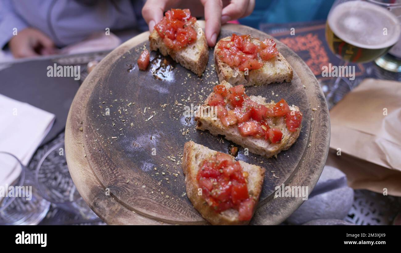 Italian Appetizer Bruschetta on Wooden Plate at restaurant. Bread and ...