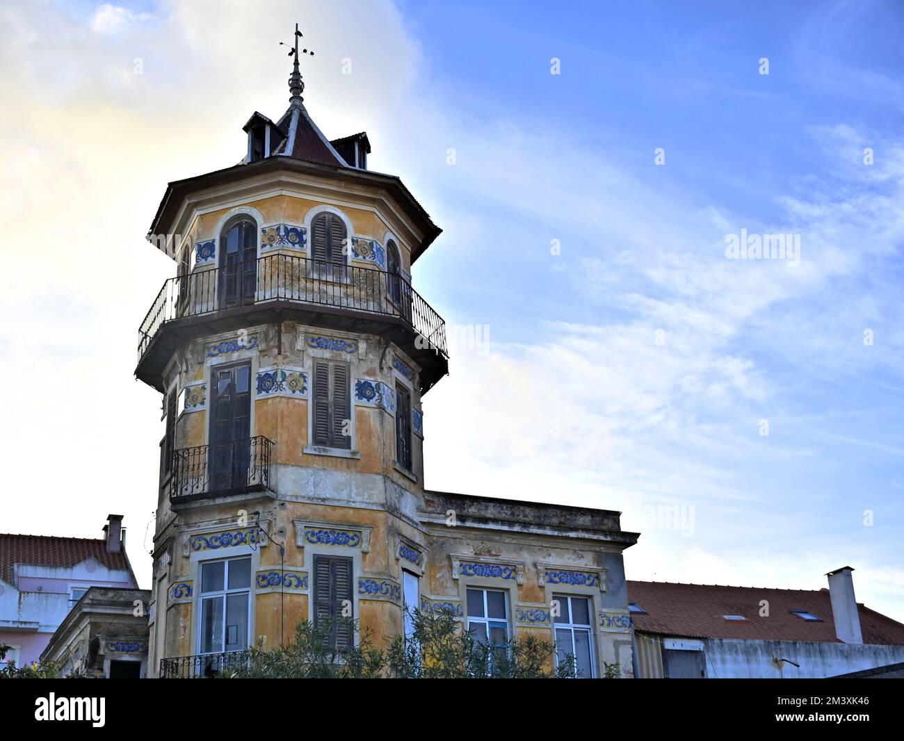 Beautiful octagonal tower with four floors, tiled friezes on facades ...