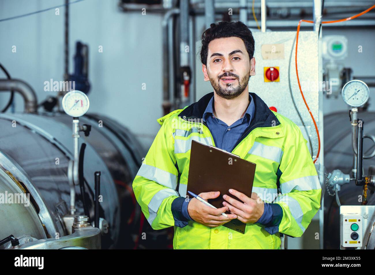 Hispanic smart confident engineer male service worker in factory ...