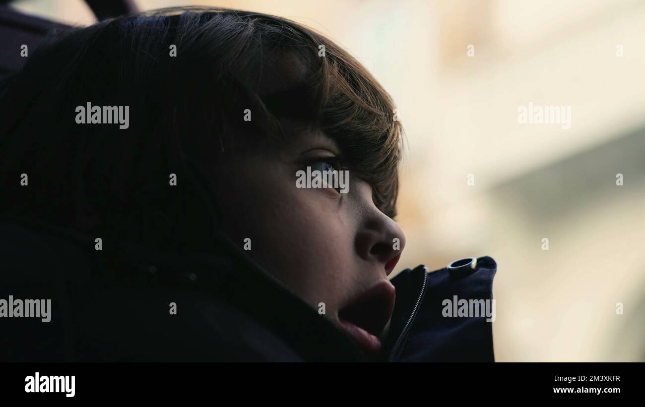 Portrait of a thoughtful little boy closeup face. Pensive contemplative ...
