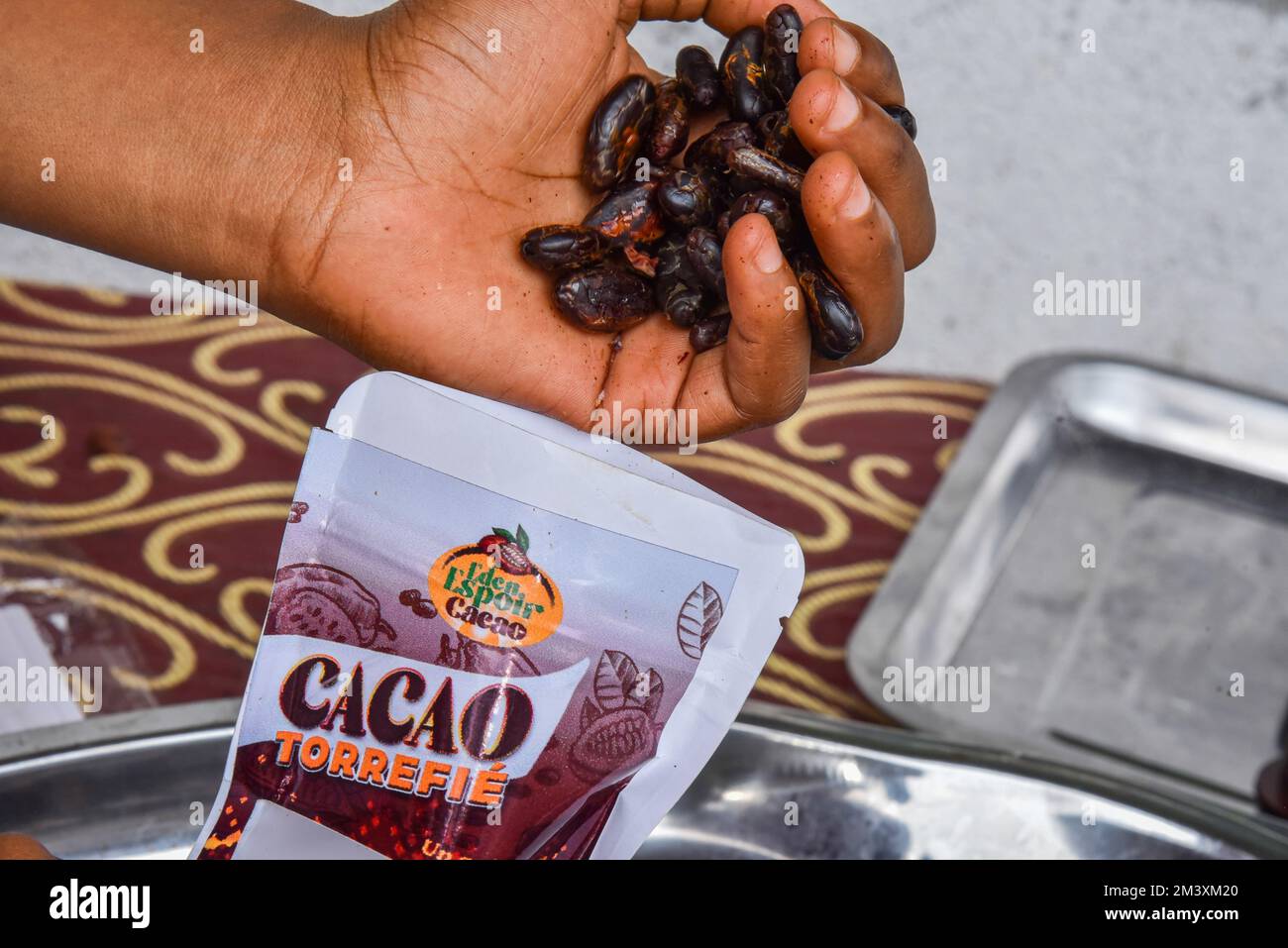 Yaounde, Cameroon. 6th Dec, 2022. A person bags roasted cocoa beans at ...