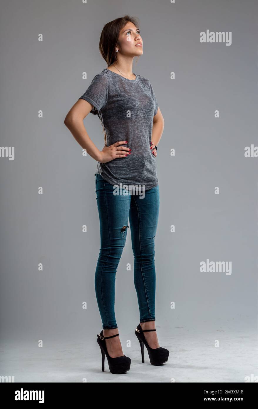 Three-quarter-length portrait of a full-length girl with her hands on ...