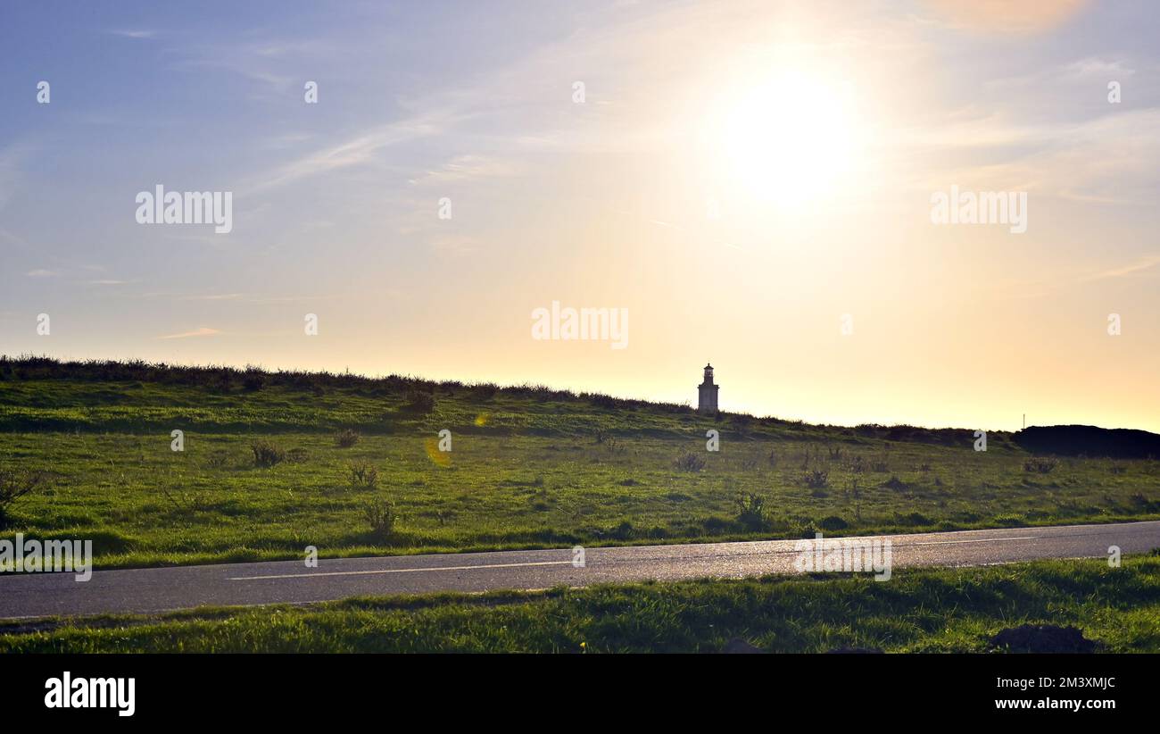 Landscape of Cape Espichel with lighthouse on coast of Atlantic Ocean in Portugal under blue sky ...