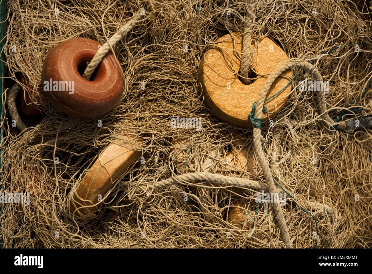 longline fishing net, sand color with red orange and yellow details ...