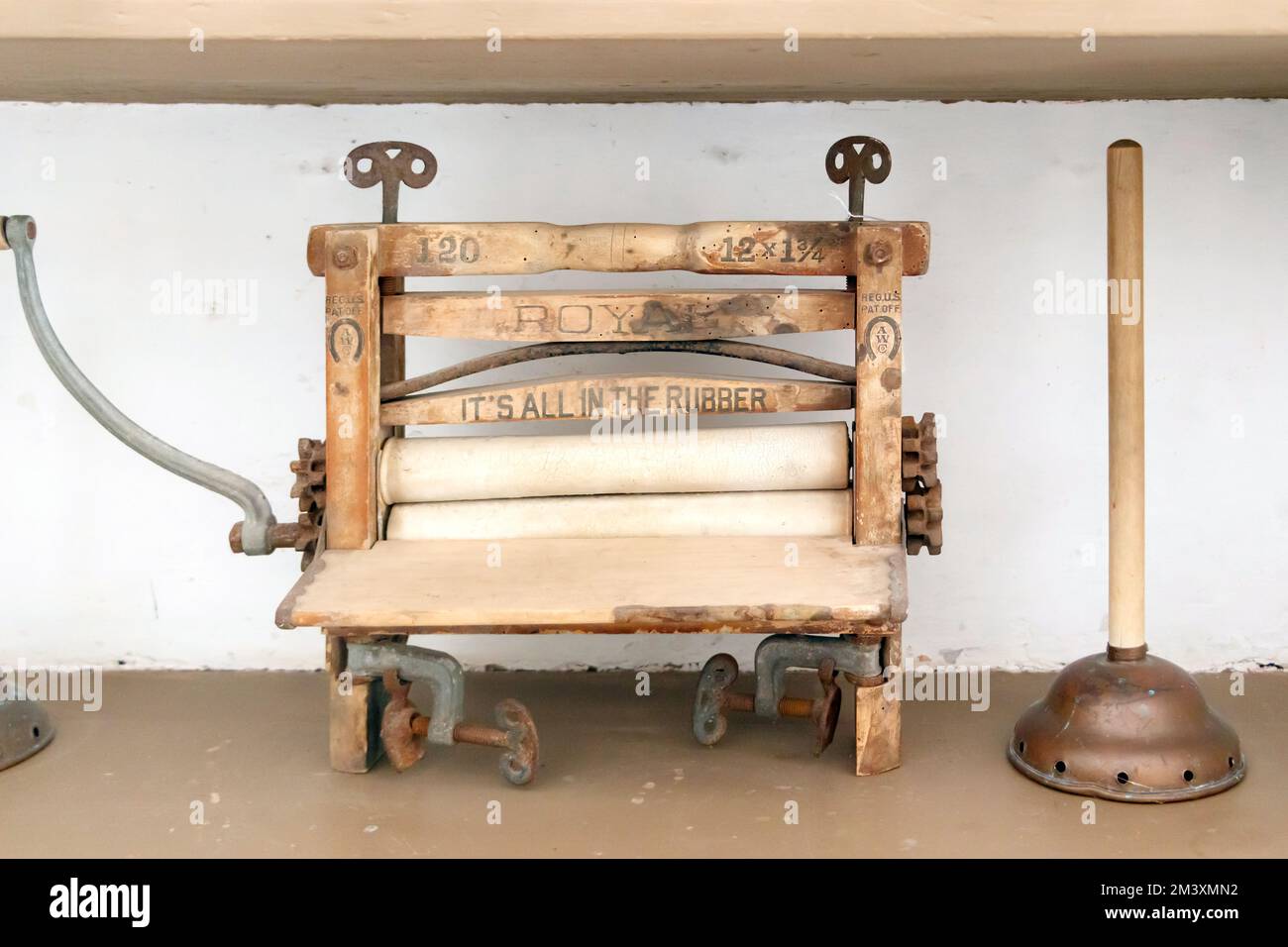 copper laundry posser or plunger and mangle in old English house ...