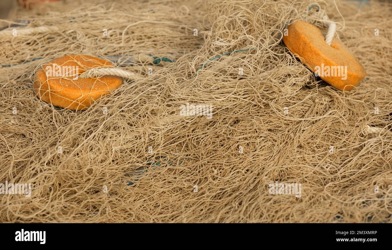 longline fishing net, sand color with red orange and yellow details ...
