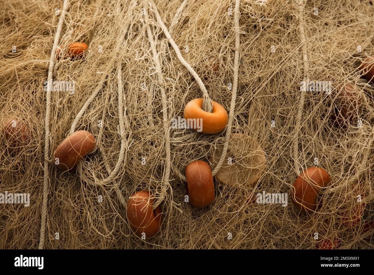 longline fishing net, sand color with red orange and yellow details ...