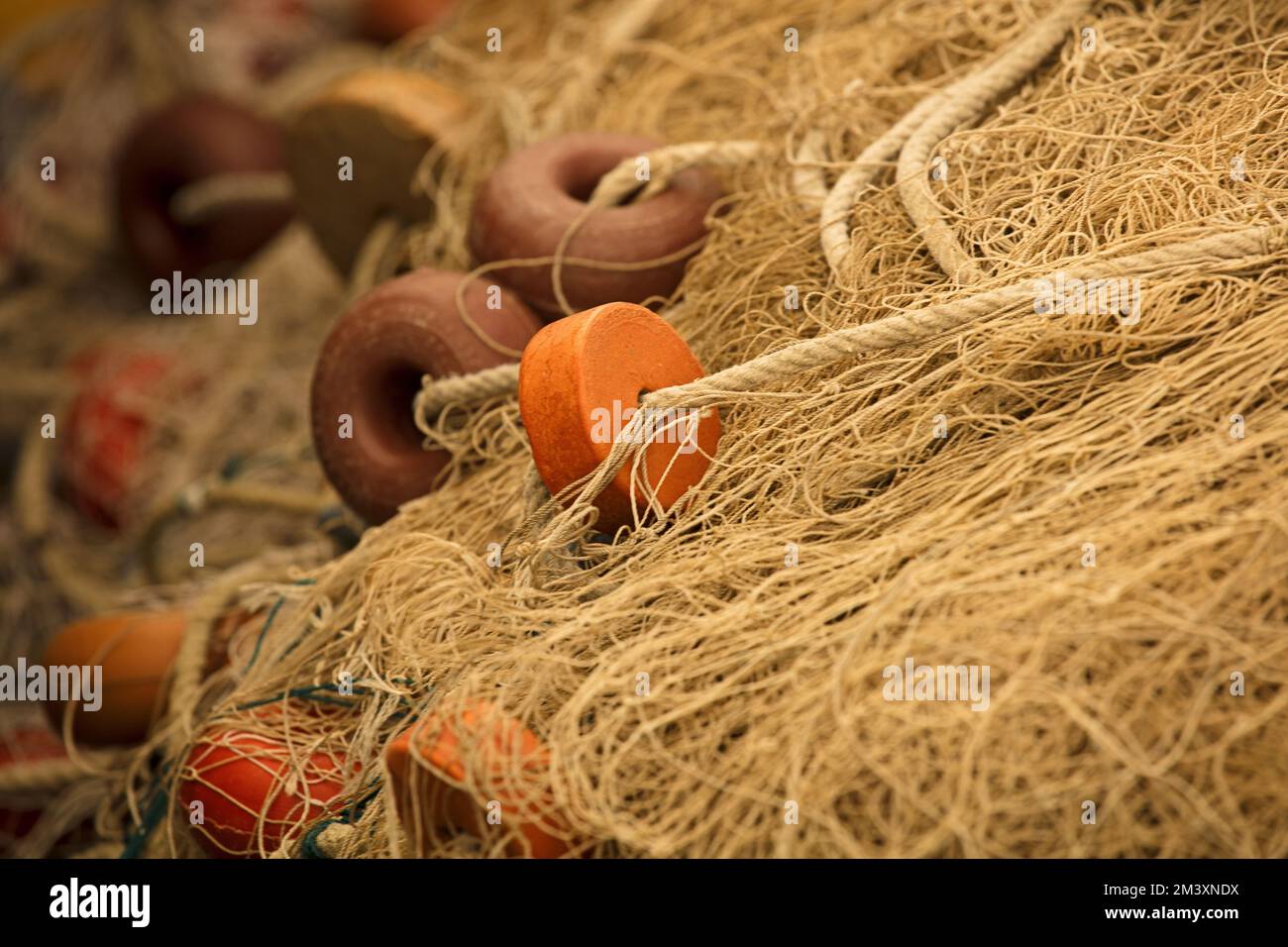 longline fishing net, sand color with red orange and yellow details ...