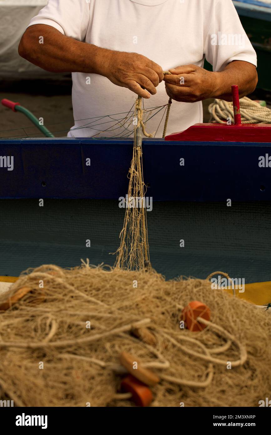 fishing net in the hands of a fisherman, preparing gear to go out to ...
