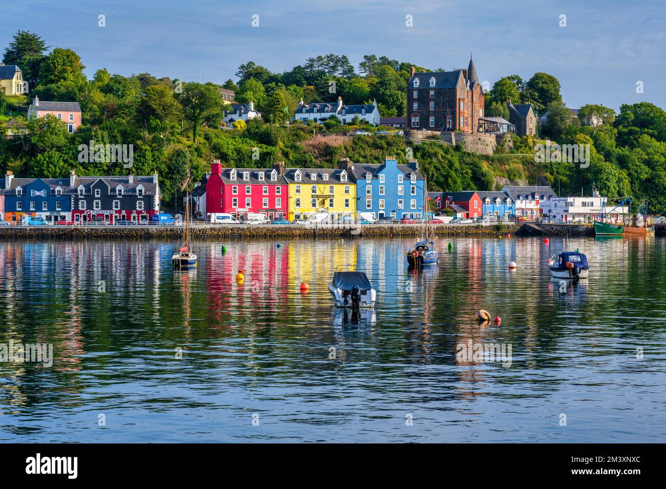 Boats anchored in Tobermory harbour with colourful reflections of the ...