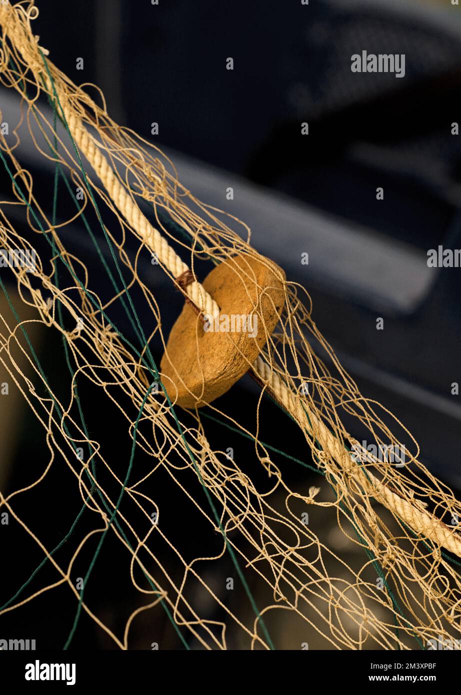 longline fishing net, sand color with red orange and yellow details ...