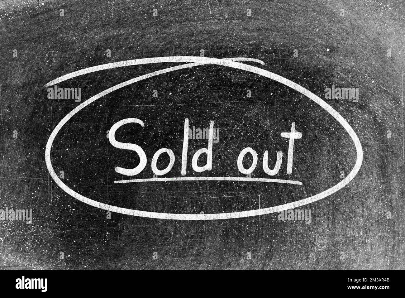 White chalk hand writing in word sold out and circle shape on ...