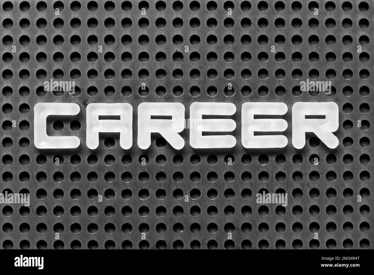 White alphabet letter in word career on black pegboard background Stock ...