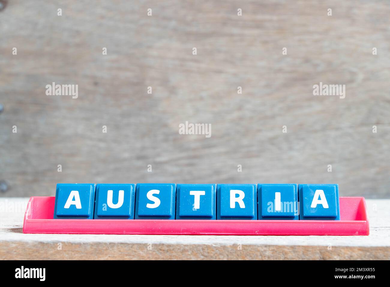 Tile alphabet letter with word austria in red color rack on wood ...