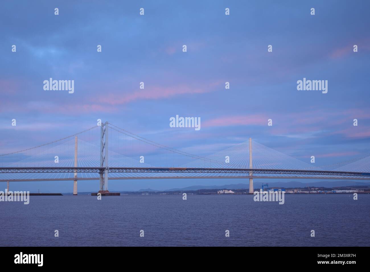 Two large bridges over the sea bay with clouds in the dawn sunlight ...