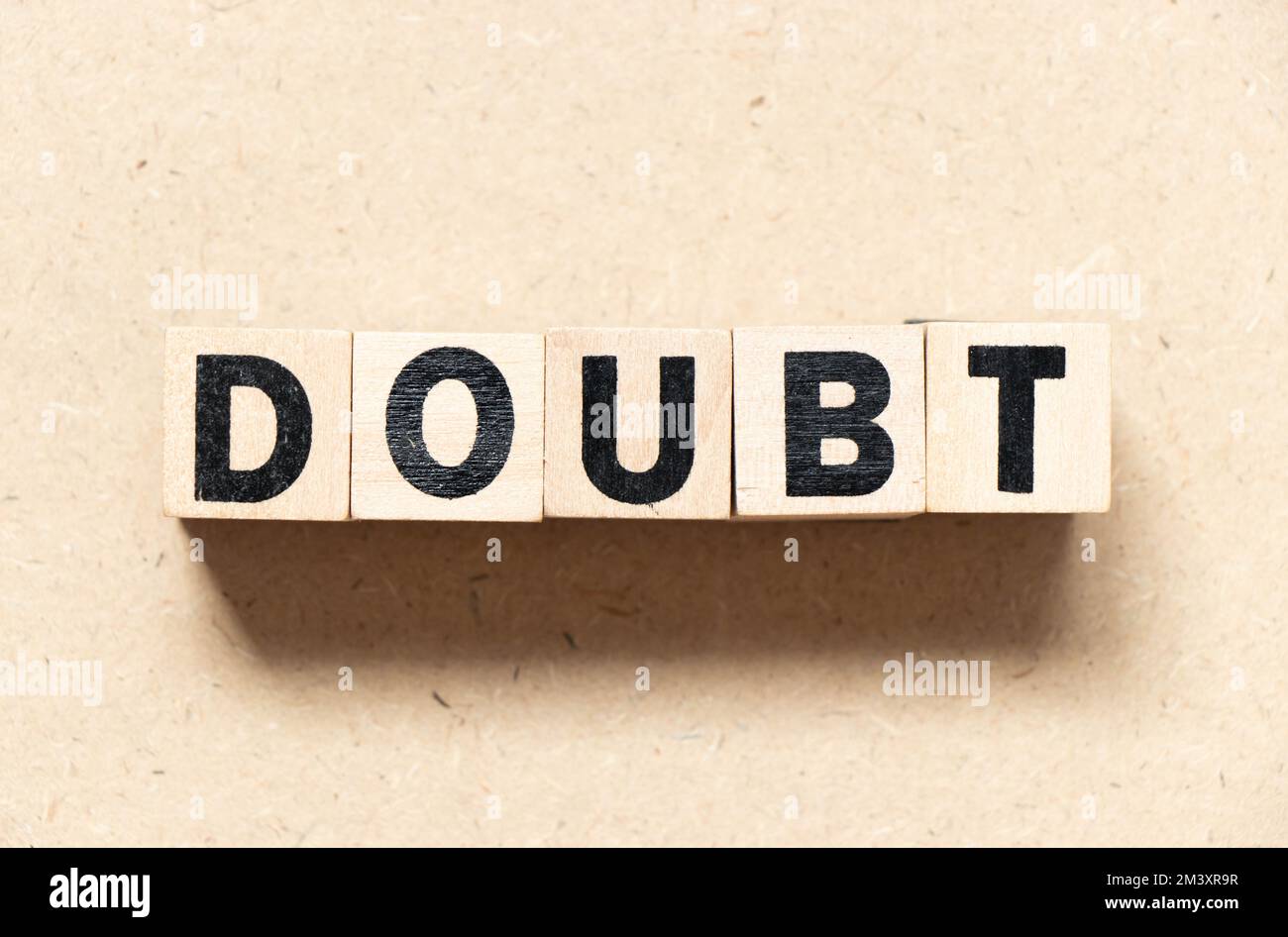 Alphabet letter block in word doubt on wood background Stock Photo - Alamy
