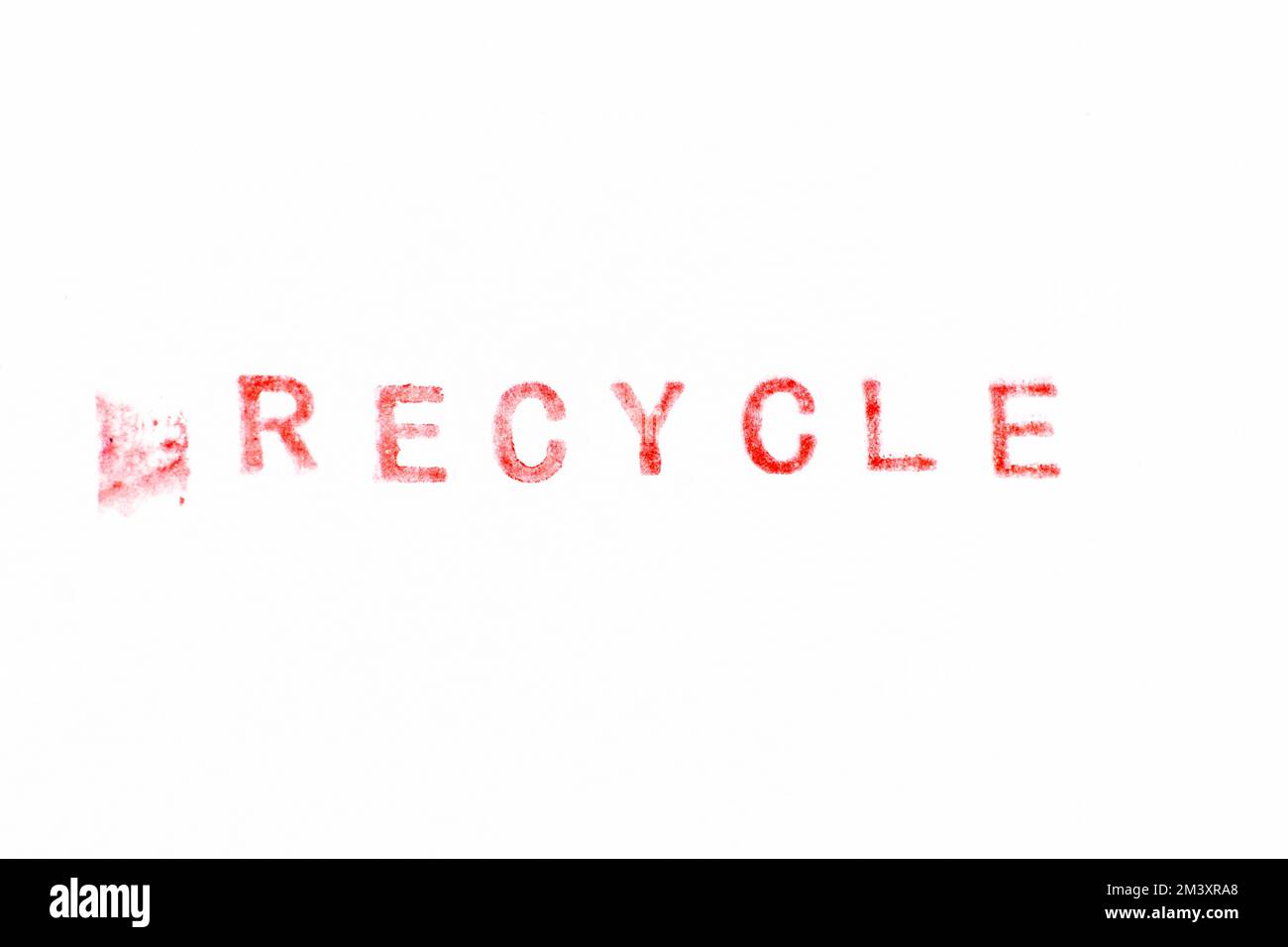 Red color ink rubber stamp in word recycle on white paper background ...