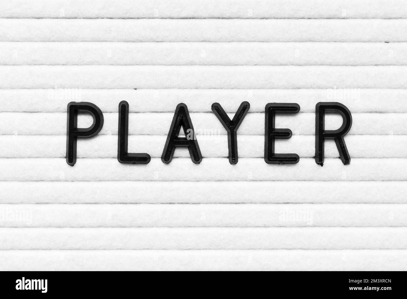 Black alphabet letter in word player on white felt board background ...